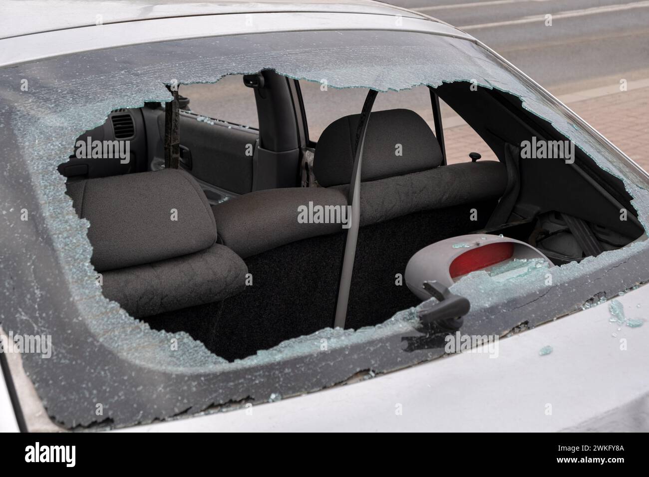 The rear window of a car shattered and removed, items were stolen ...