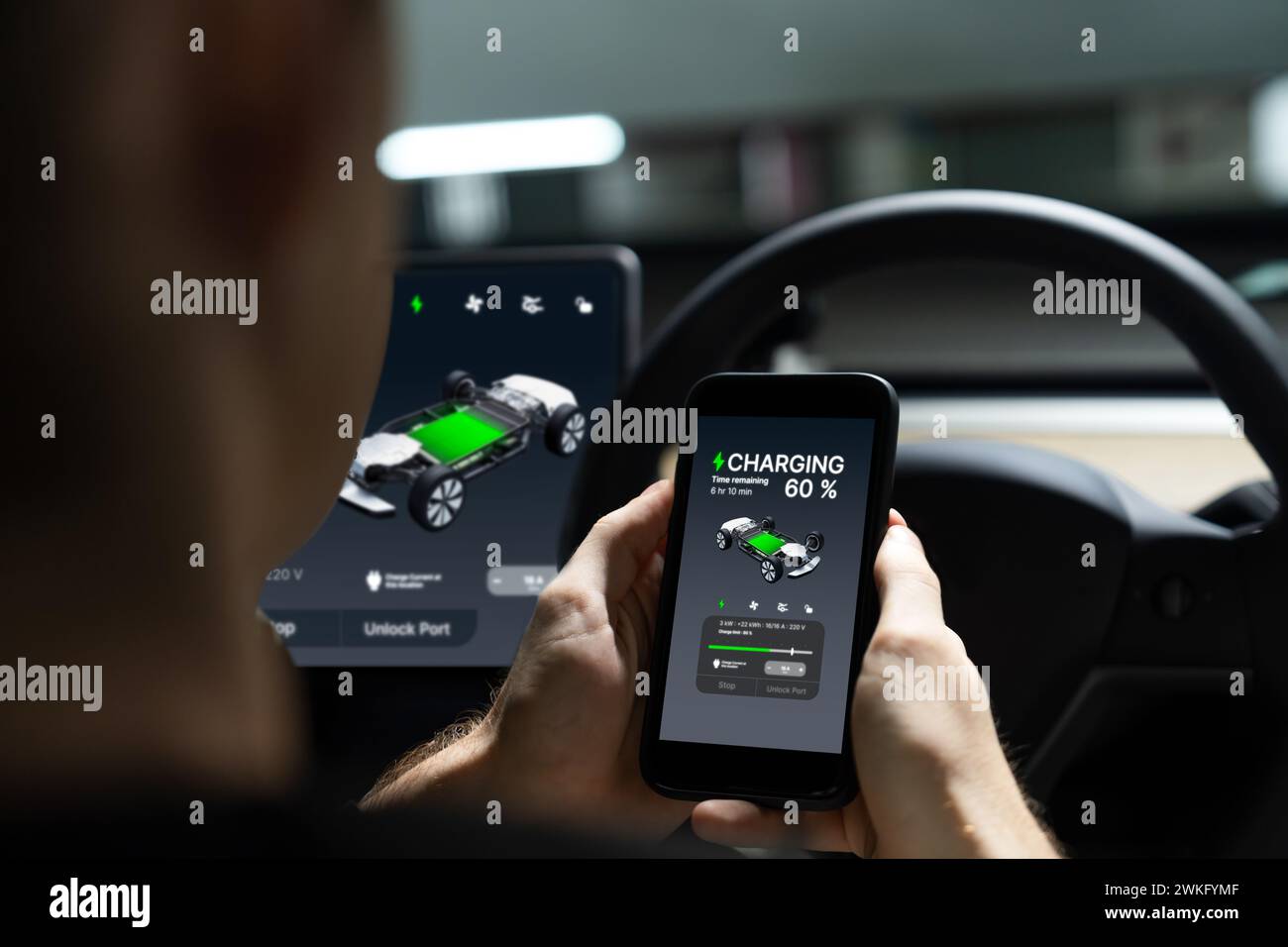 Electric car driver checks battery charging status, range and charging ...