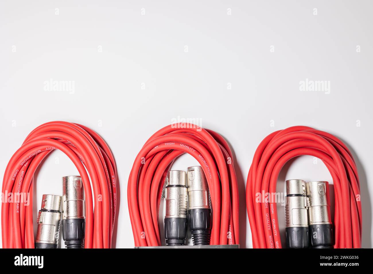 Red microphone cables bundled on white background Stock Photo - Alamy