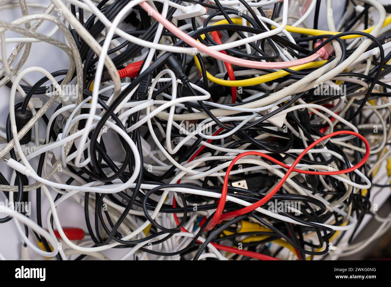 A pile of various used tech peripheral cables, connectors, and plugs ...