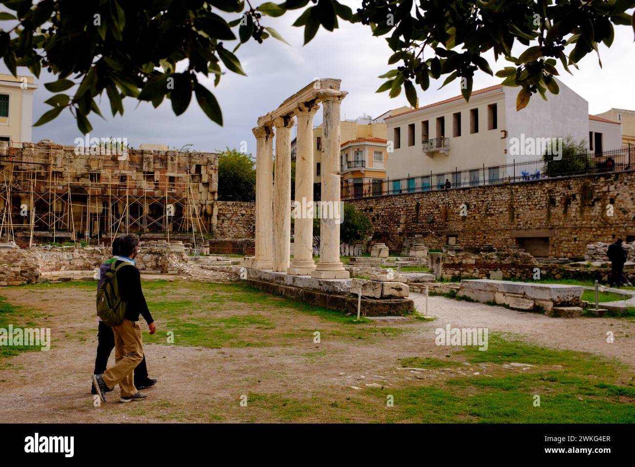 Tourists walk by Ancient Greek ruins in Athens, Greece Stock Photo - Alamy