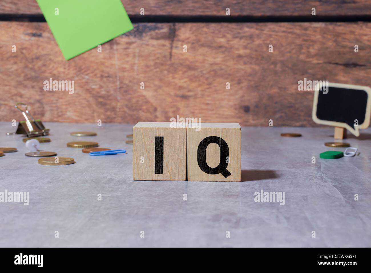 Text IQ on wooden cubes on a pink background, copy space. Coefficient ...
