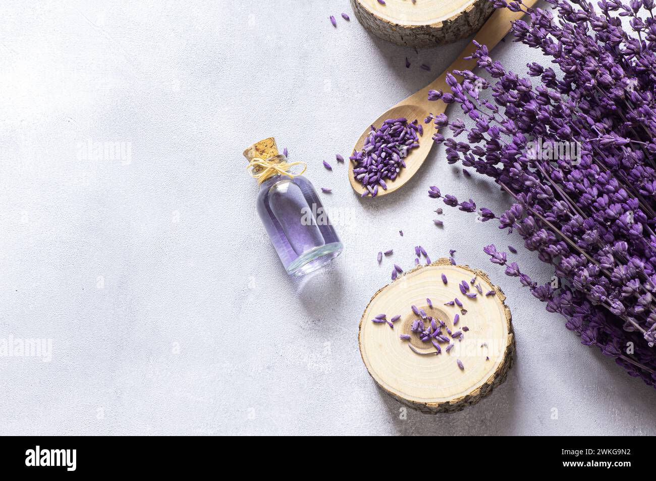 Glass bottle of Lavender essential oil with dried lavender flowers and ...