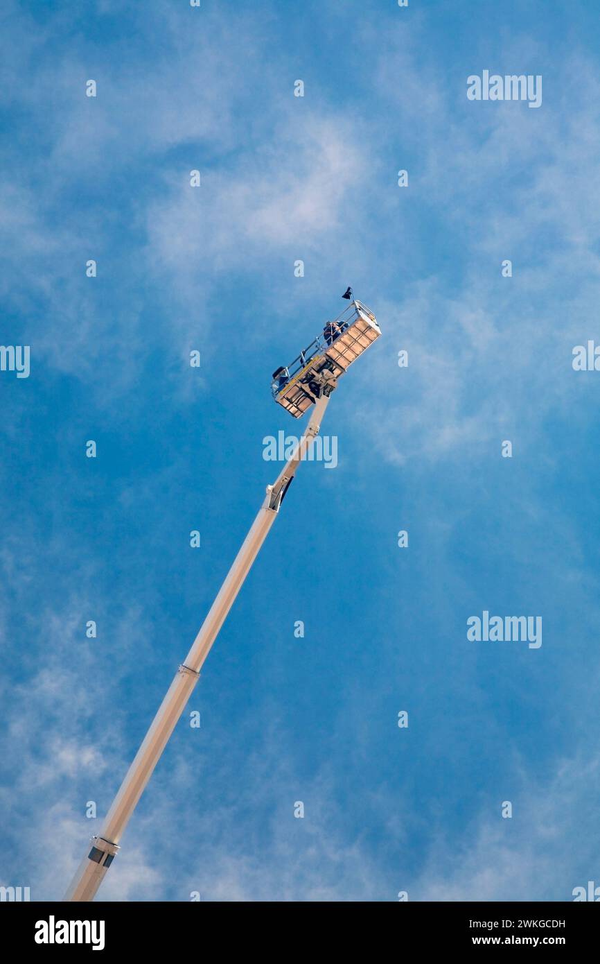 Construction workers high up on hydraulic lift platform, Vienna ...