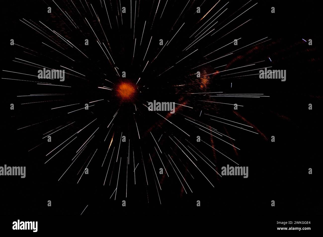 Purple, white and orange fireworks in night sky Stock Photo - Alamy