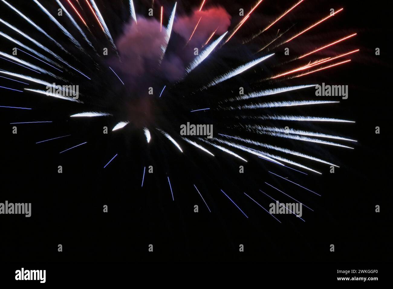 White, blue and red fireworks with zoom motion effect in night sky ...