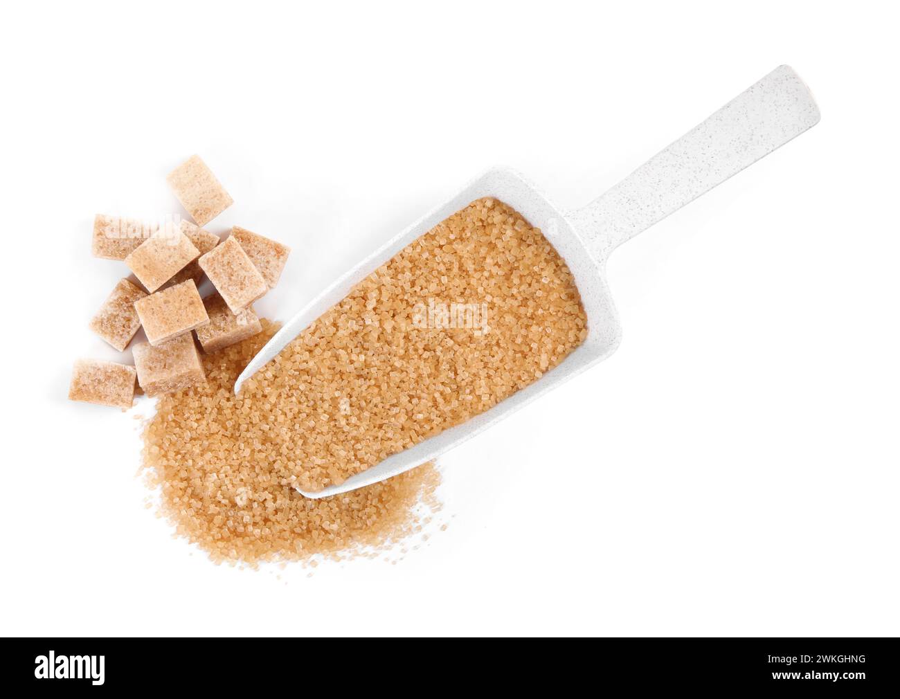 Different types of brown sugar and scoop isolated on white, top view ...