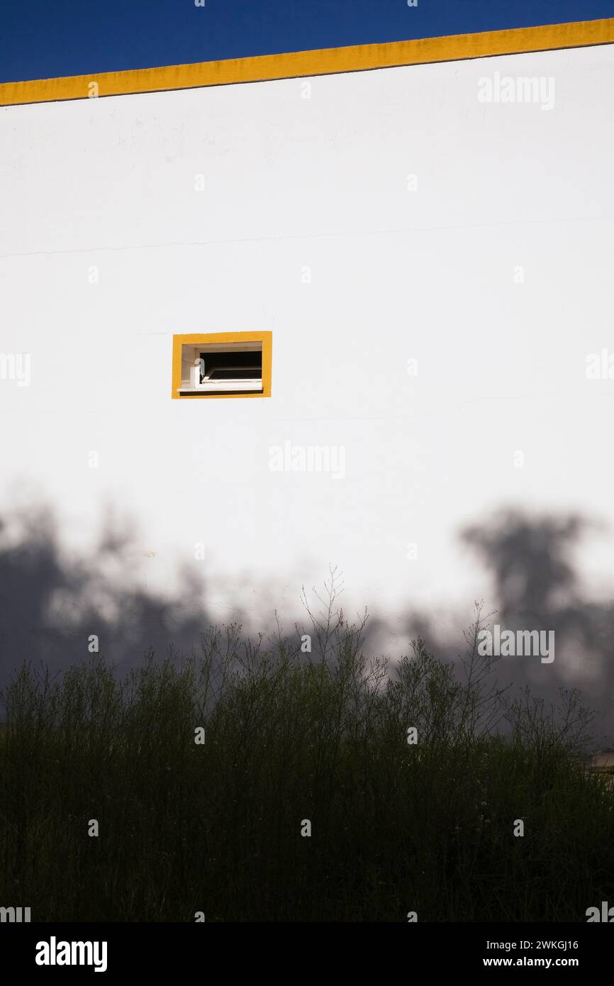 Small yellow window on side of white building wall, Granada region ...