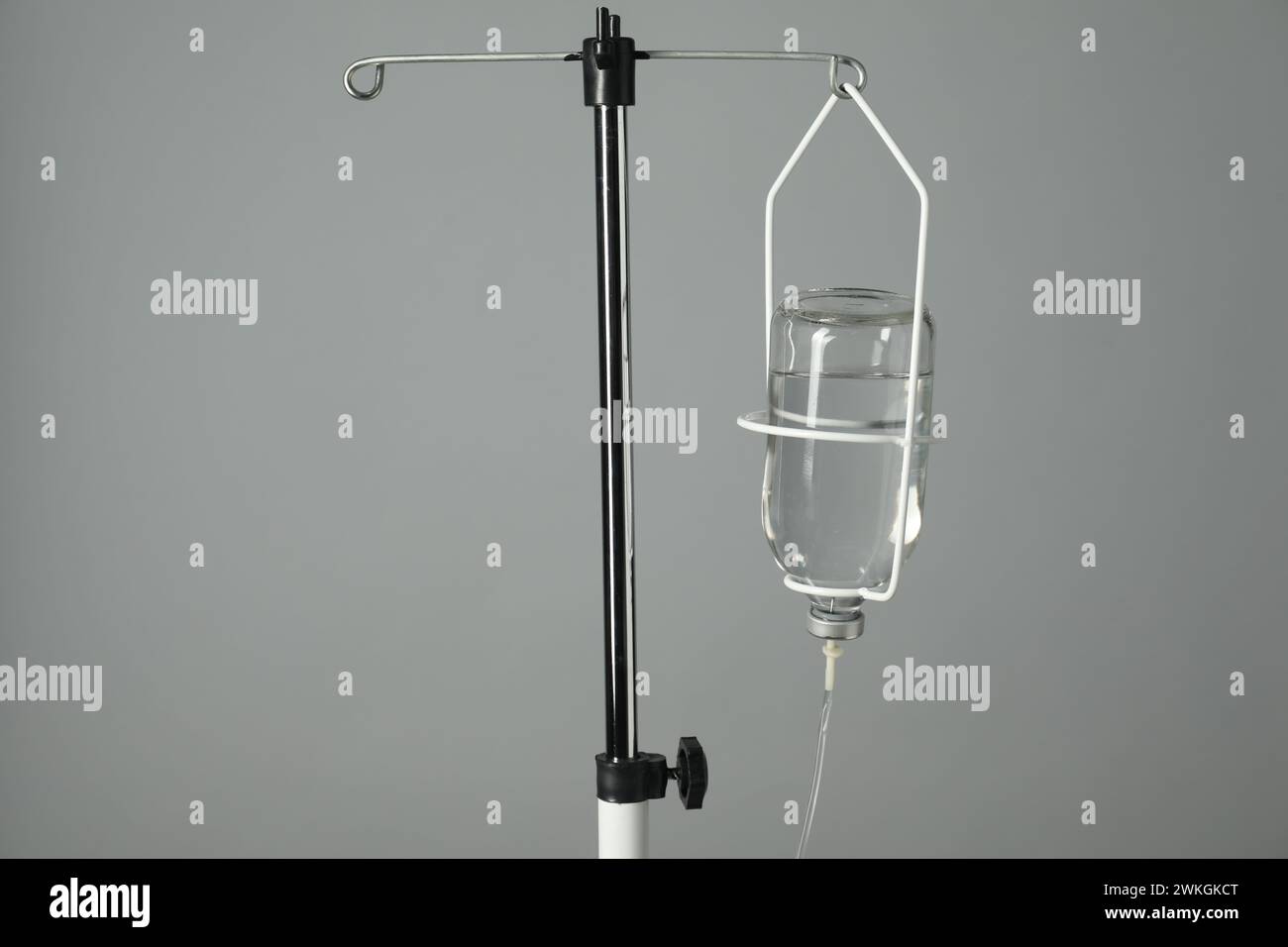 IV infusion set on pole against grey background Stock Photo - Alamy