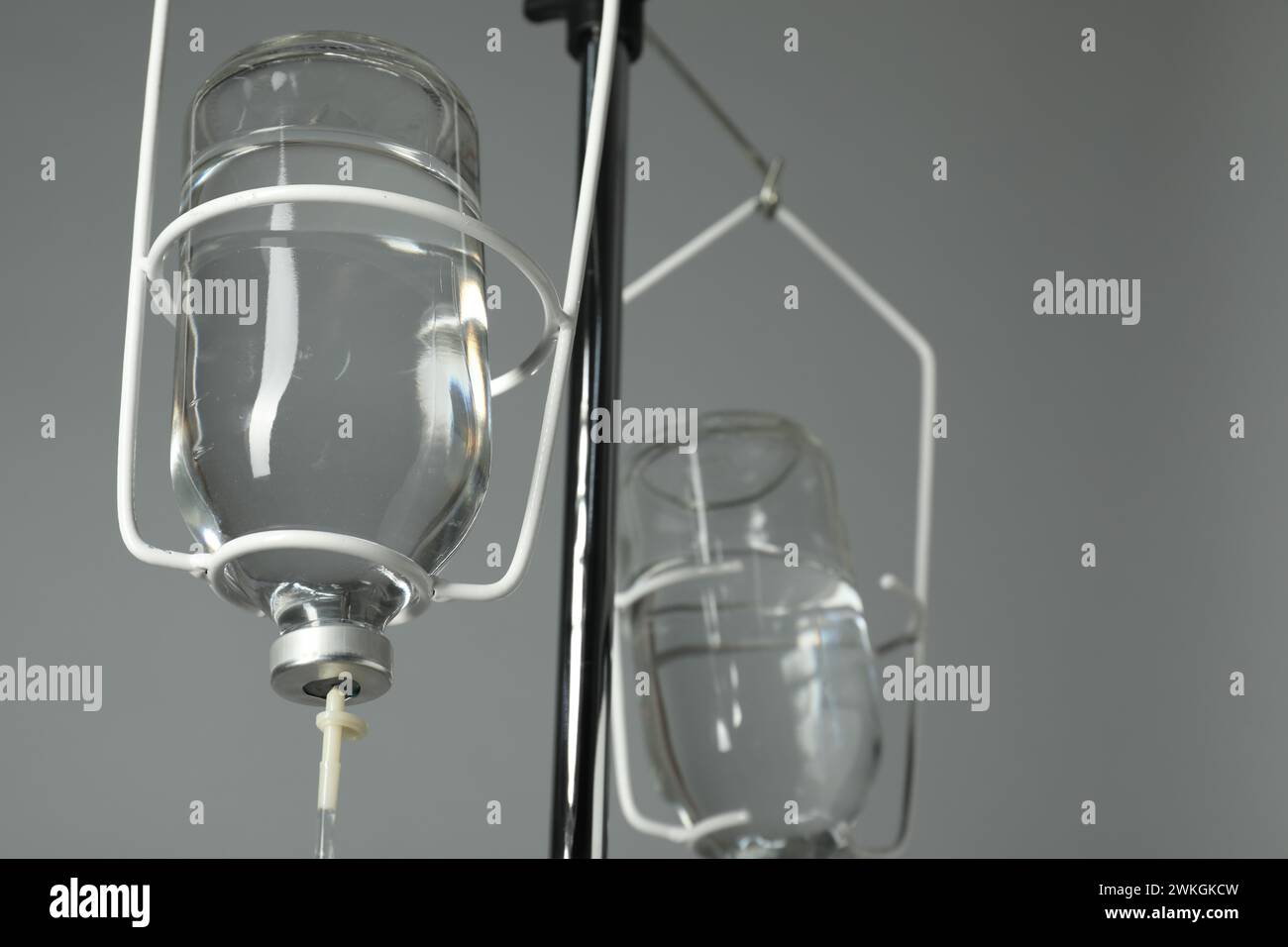 IV infusion set on pole against grey background, closeup Stock Photo ...