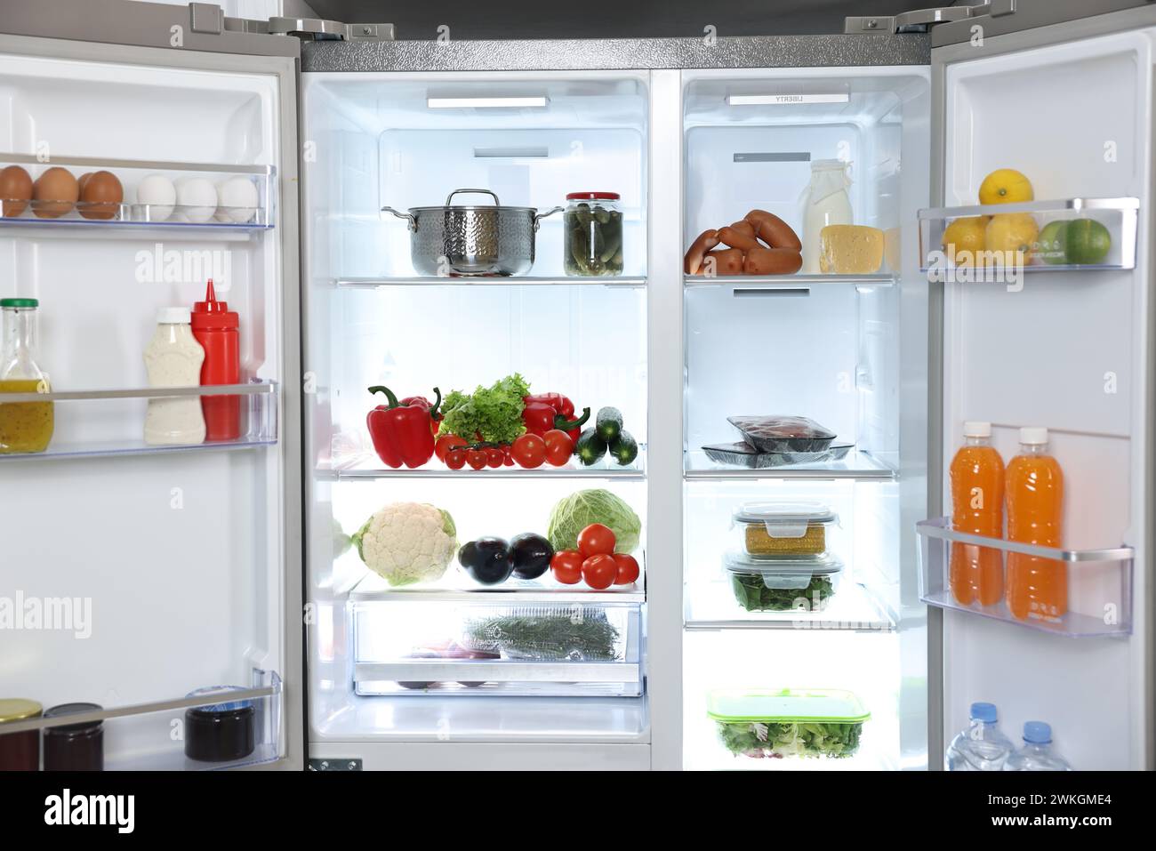 Modern open refrigerator full of different products indoors Stock Photo ...