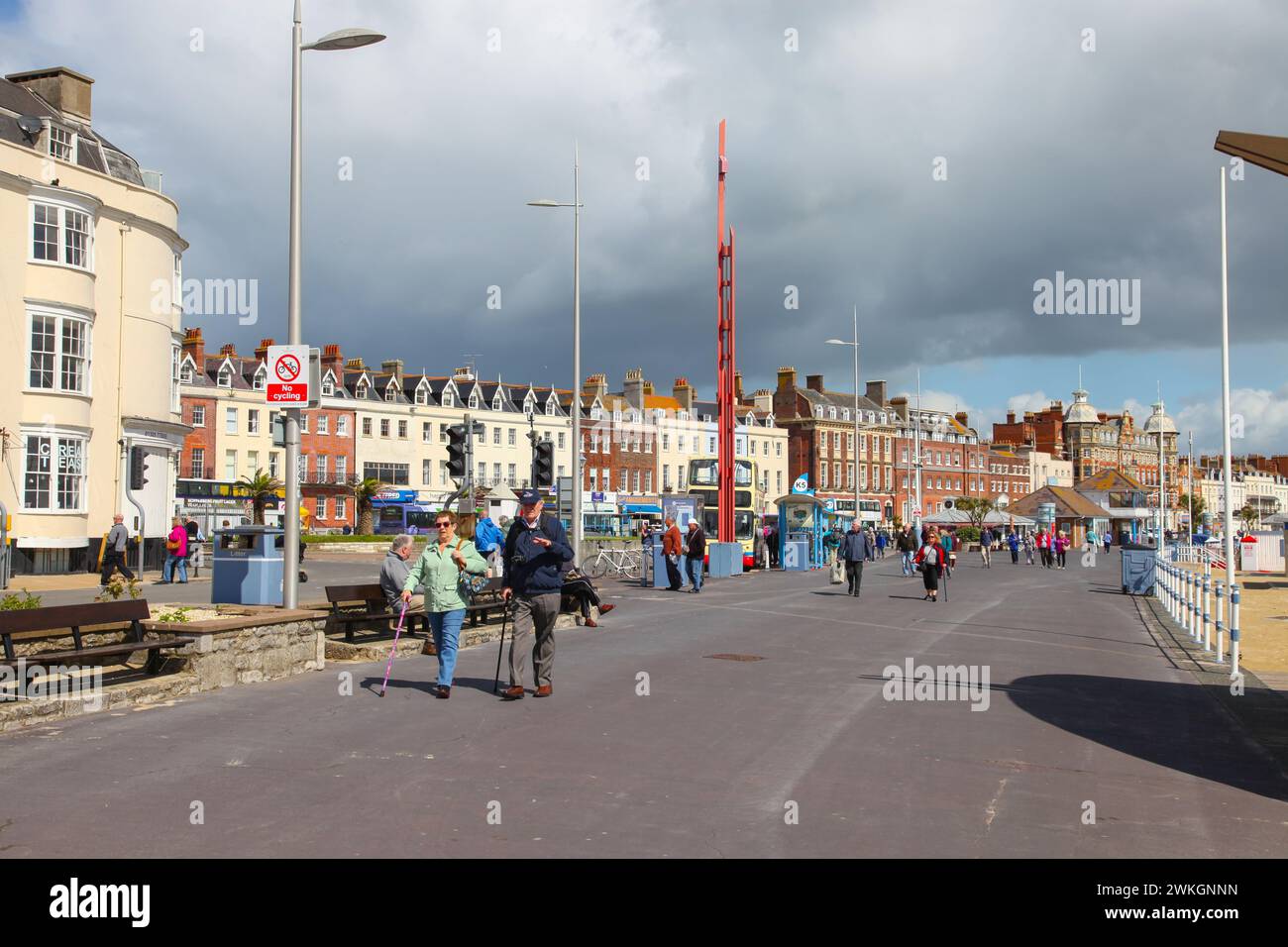 People walking along the Esplanade promenade, Weymouth, Dorset, England ...