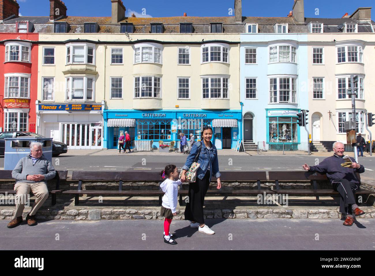 People walking along the Esplanade promenade, Weymouth, Dorset, England ...