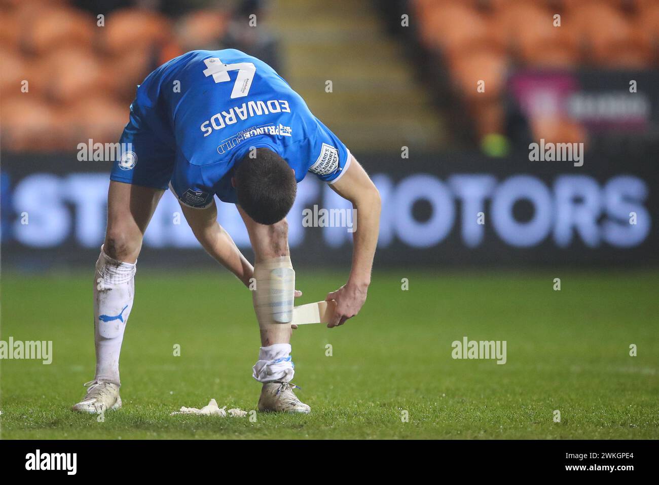 Ronnie Edwards of Peterborough United tapes his shinpad to his leg ...