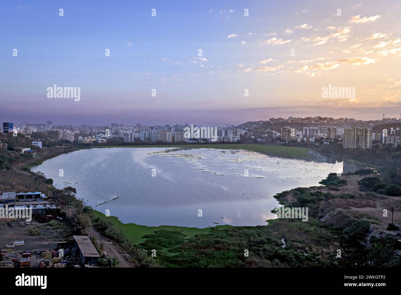 Beautiful Sunrise over tall buildings and Jambhulwadi lake in Pune ...