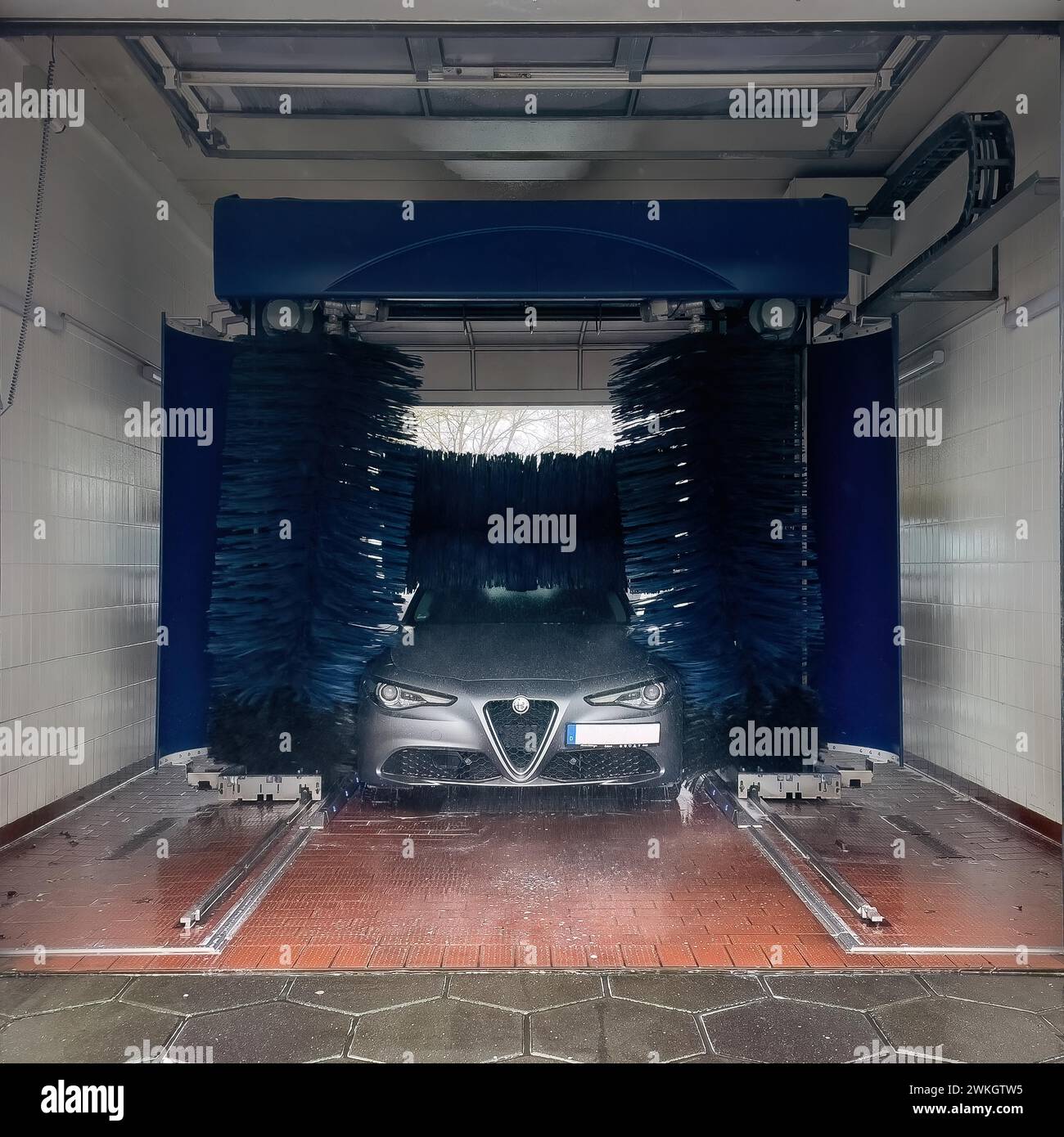 View of a car wash, Alfa Romeo being washed in a car wash with textile ...