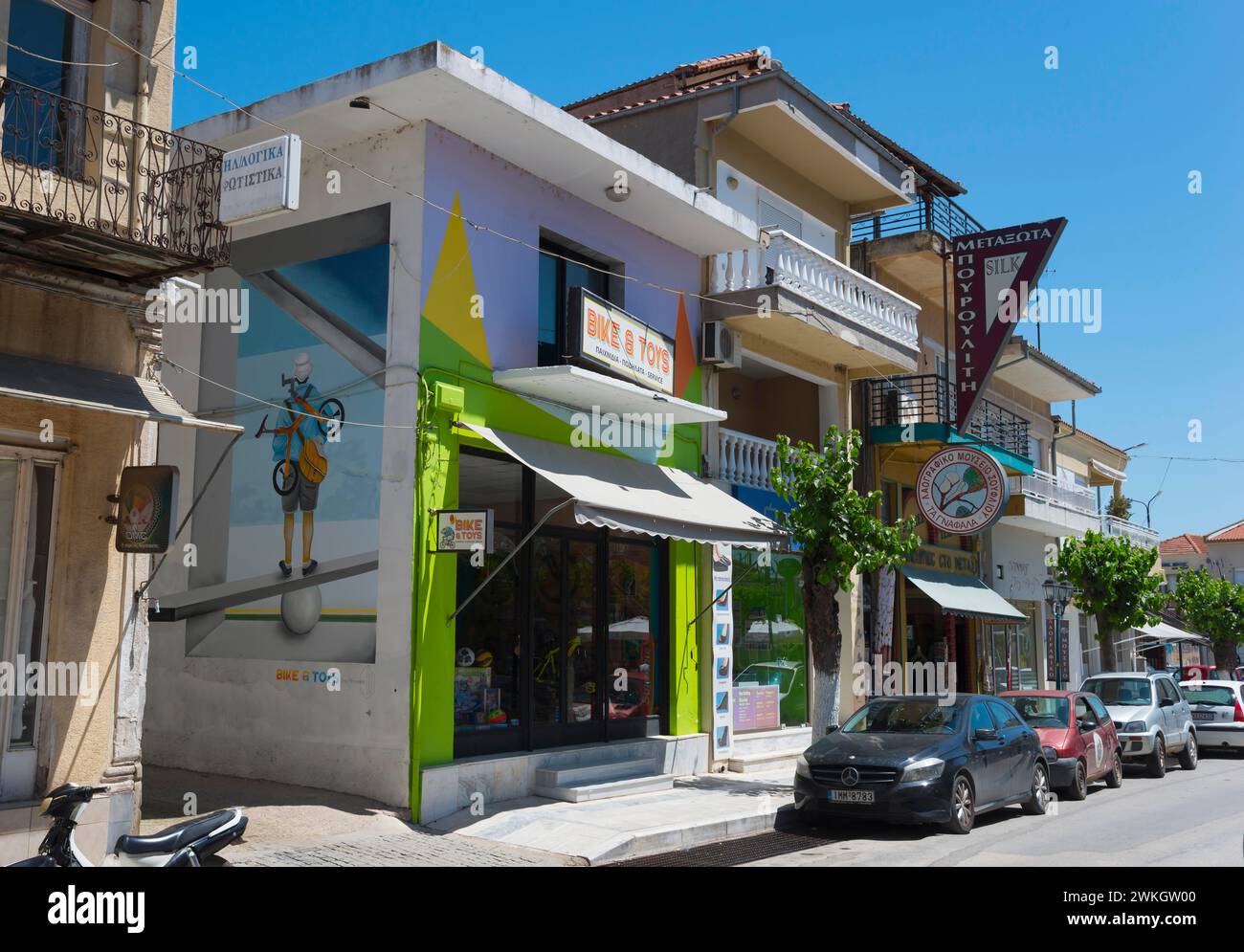 Modern building with a colourful facade and parked vehicles on the ...