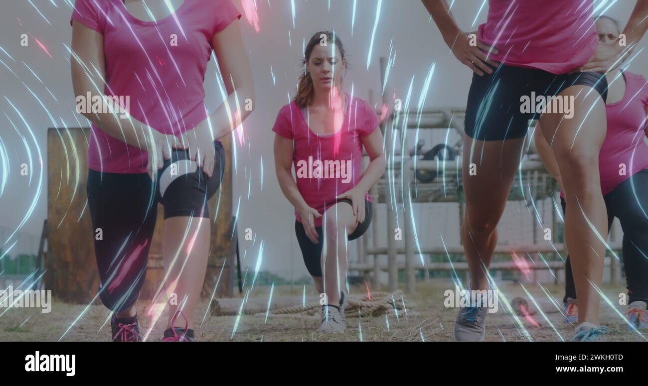 Image of light trails over caucasian women at obstacle course ...