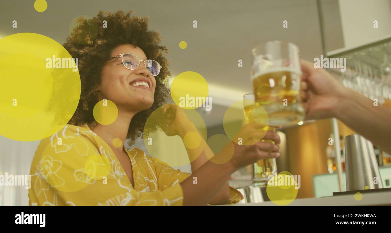 Image of spots over happy biracial woman with caucasian friend drinking ...