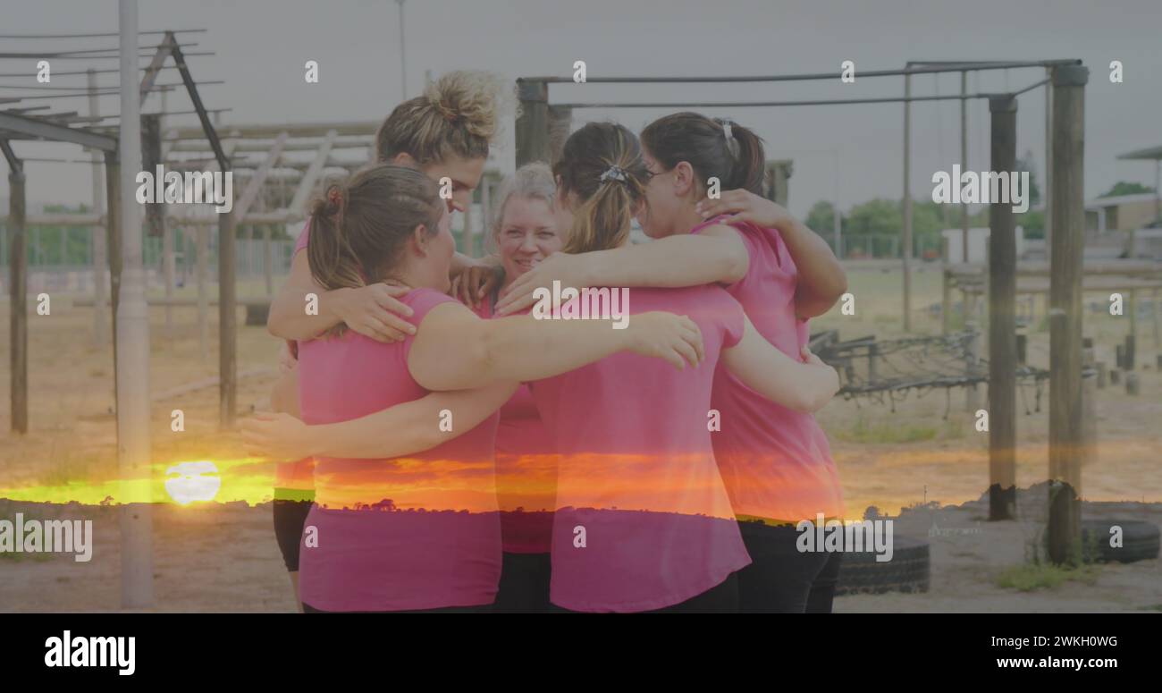 Image of sunset over diverse women at obstacle course embracing Stock ...