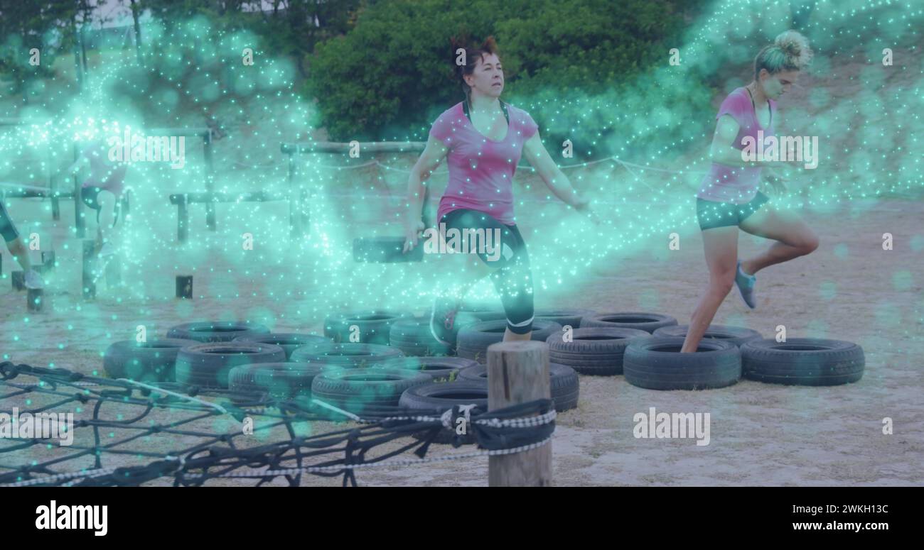 Image of white spots over diverse women at obstacle course running ...