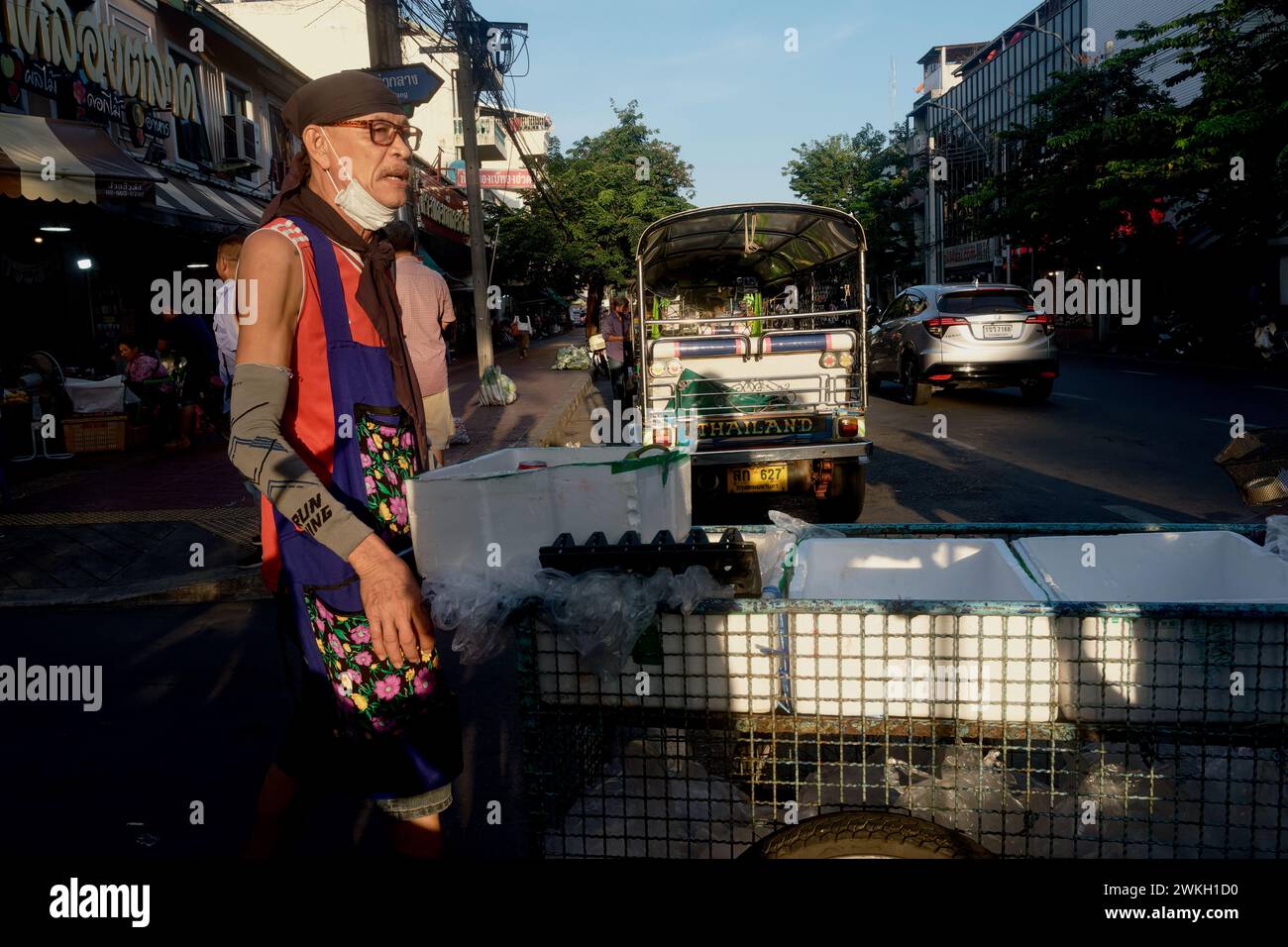 A mobile street vendor pushing his handcart at (market) Pak Klong Talad ...