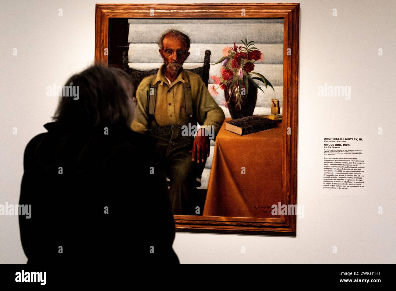 A visitor examines 'Uncle Bob' painting by prolific artist Archibald J ...