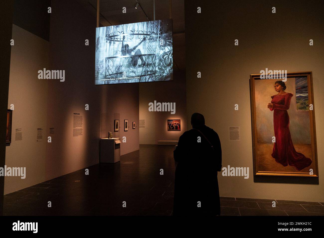 New York, USA. 20th Feb, 2024. A visitor watches a video clip of ...