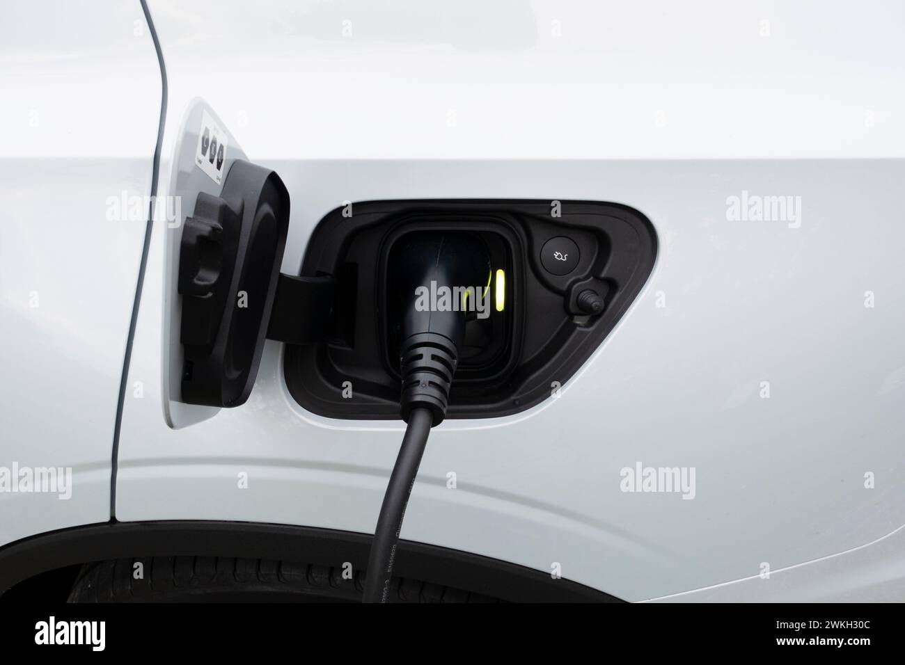 Electric car being charged Stock Photo - Alamy