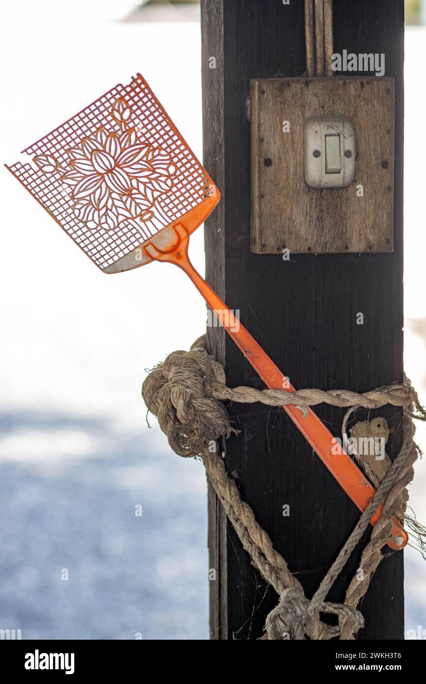An old fly swatter tied to a beam with a light switch in the yard Stock ...