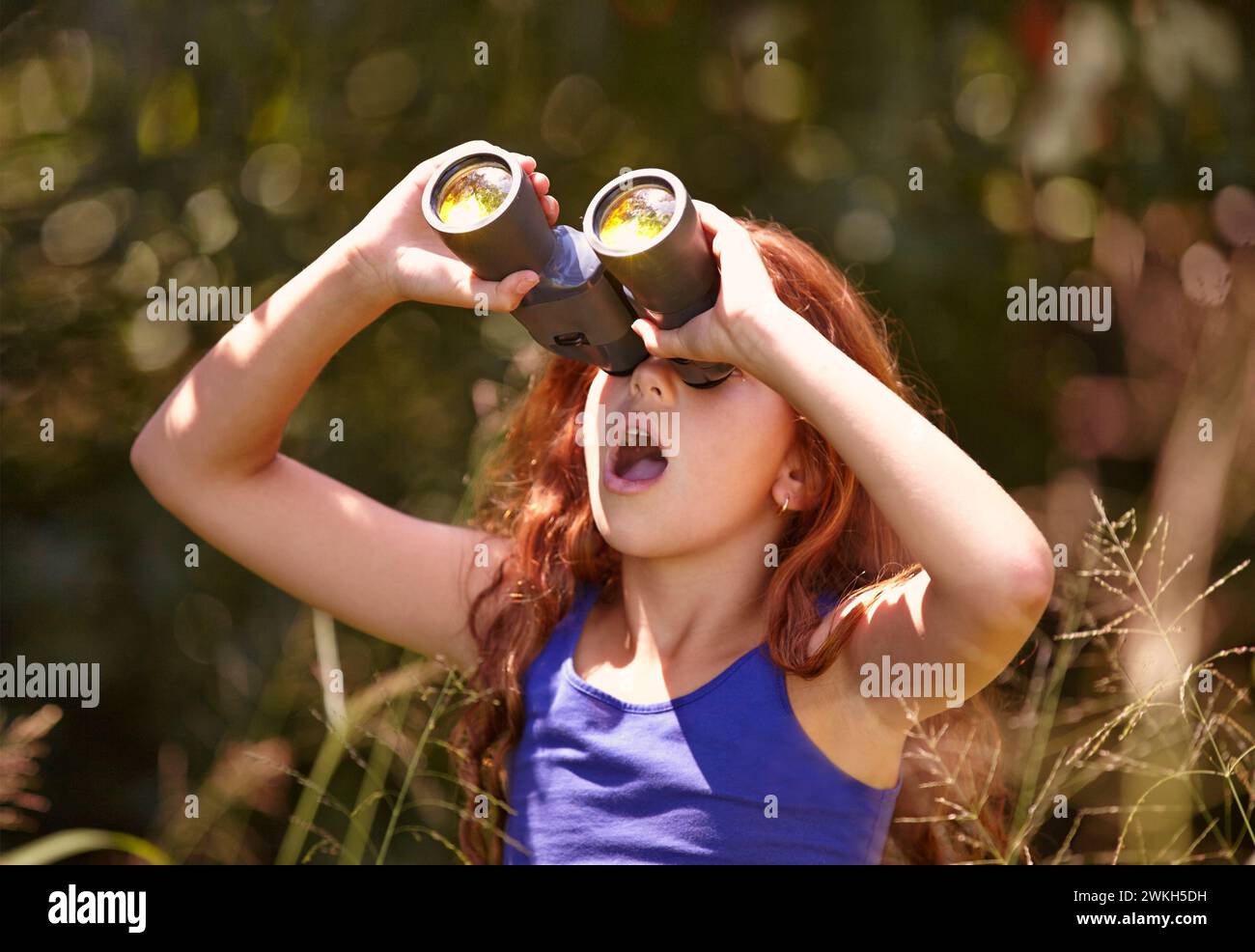 Little girl, binoculars and nature for sightseeing, explore or outdoor ...