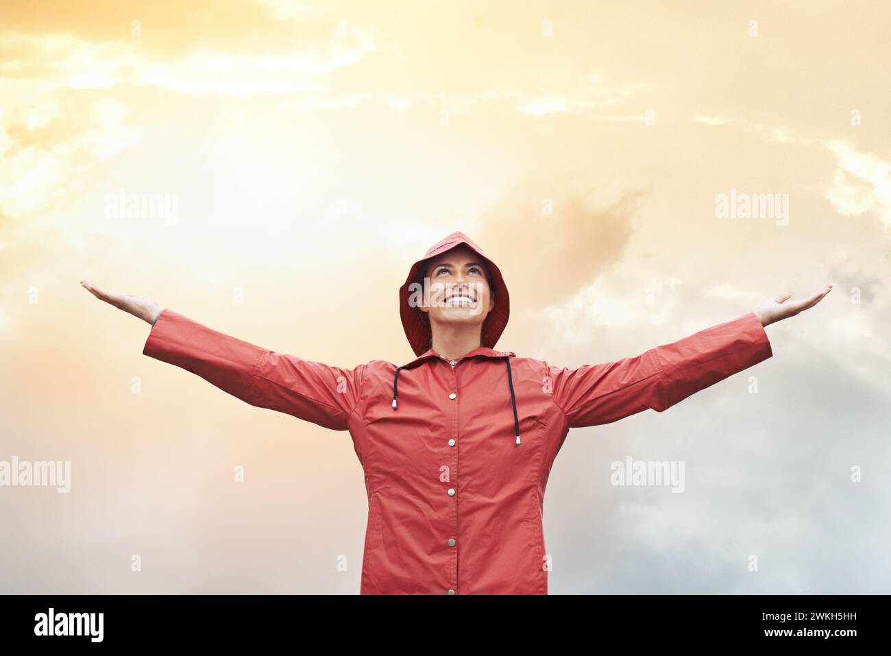 Happy woman, raincoat and freedom with weather for cloudy sky, sun or ...