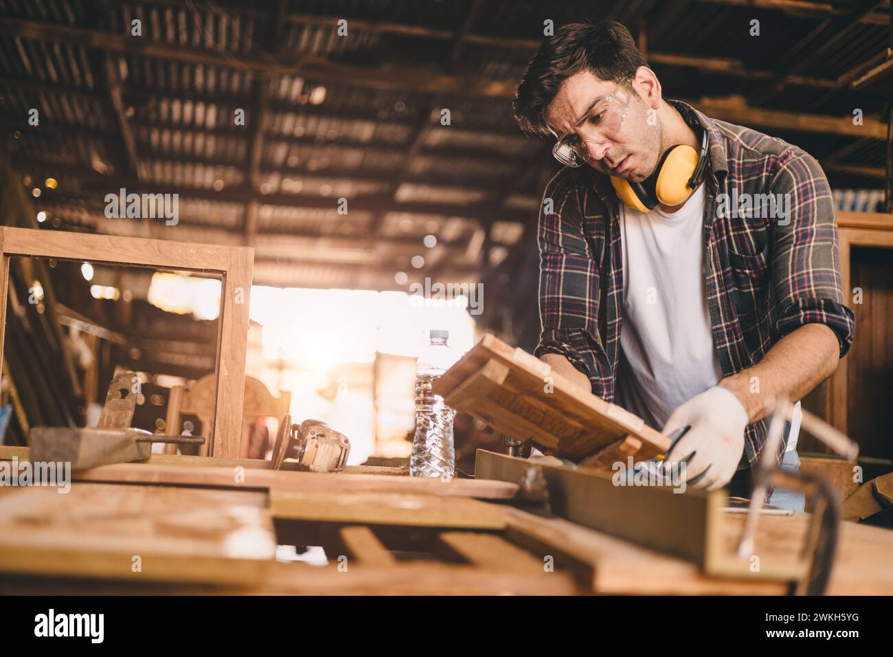 Carpenter hand made wooden furniture in workshop. Male worker 40s ...