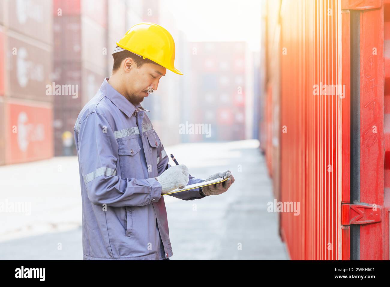 Asian male customs worker smart working check loading cargo container ...