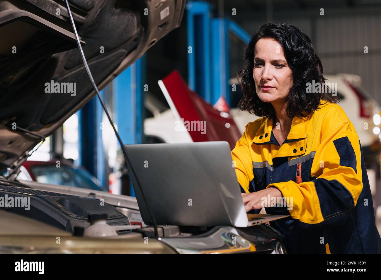 auto mechanic car engineer using laptop computer tuning ECU diagnosis analysis monitor engine ...