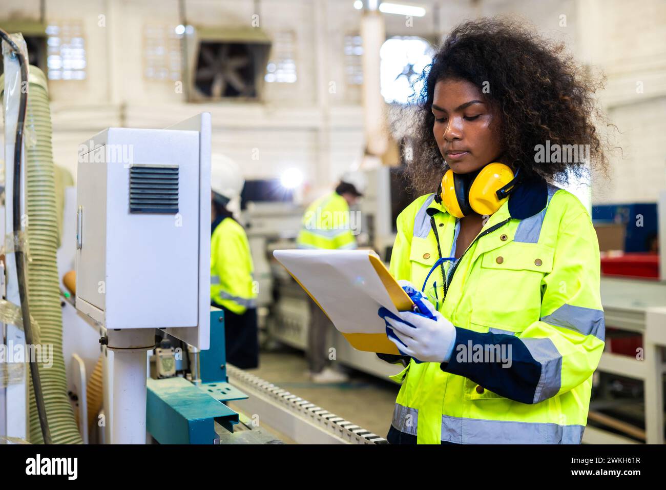 African black women worker work with wood cutter machine furniture ...