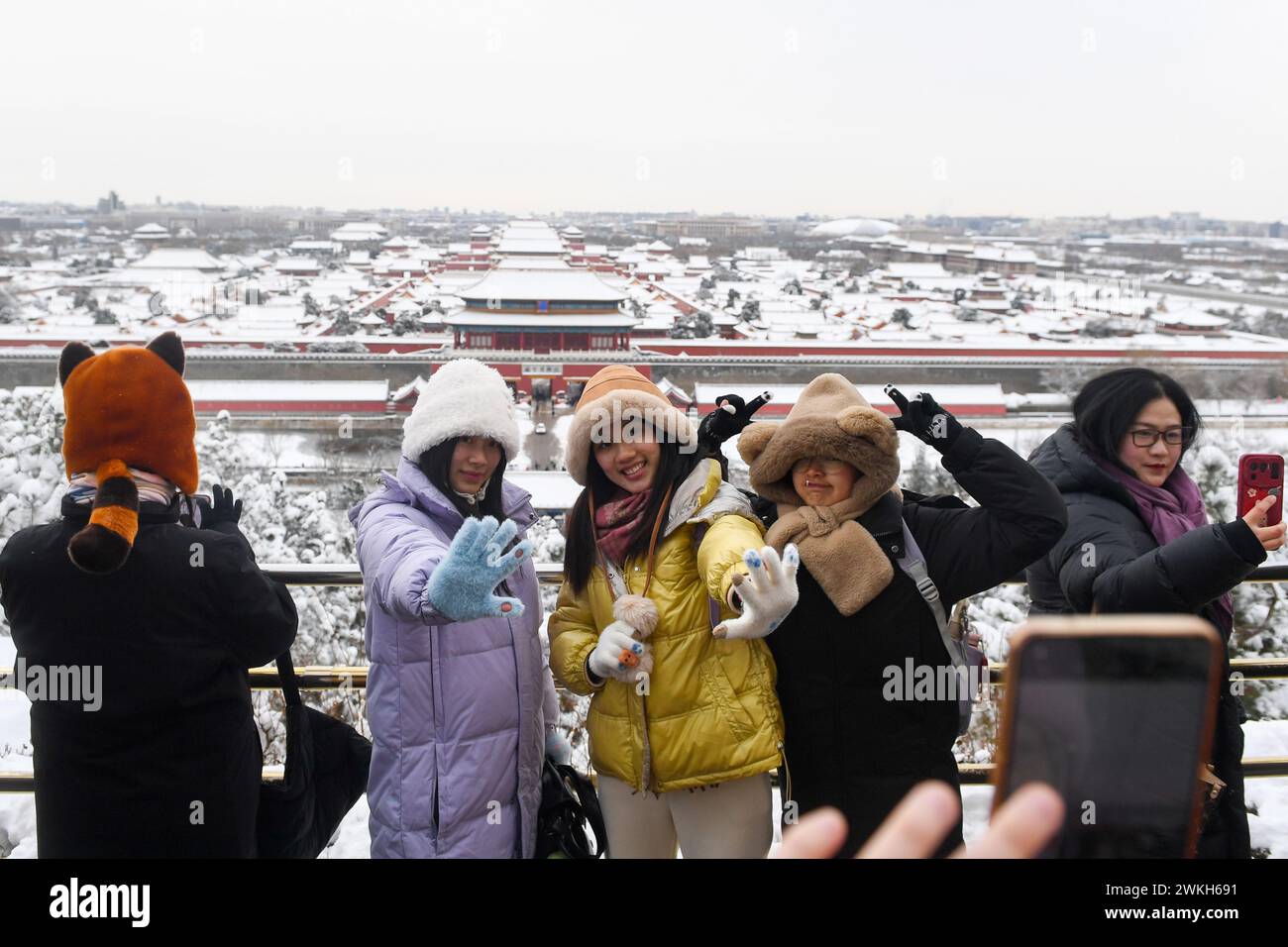 Beijing, China. 21st Feb, 2024. Visitors pose for photos with the ...
