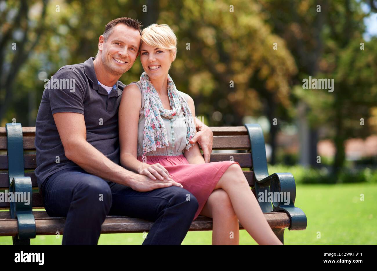 Portrait, hug and couple relax in a garden with love, support and ...