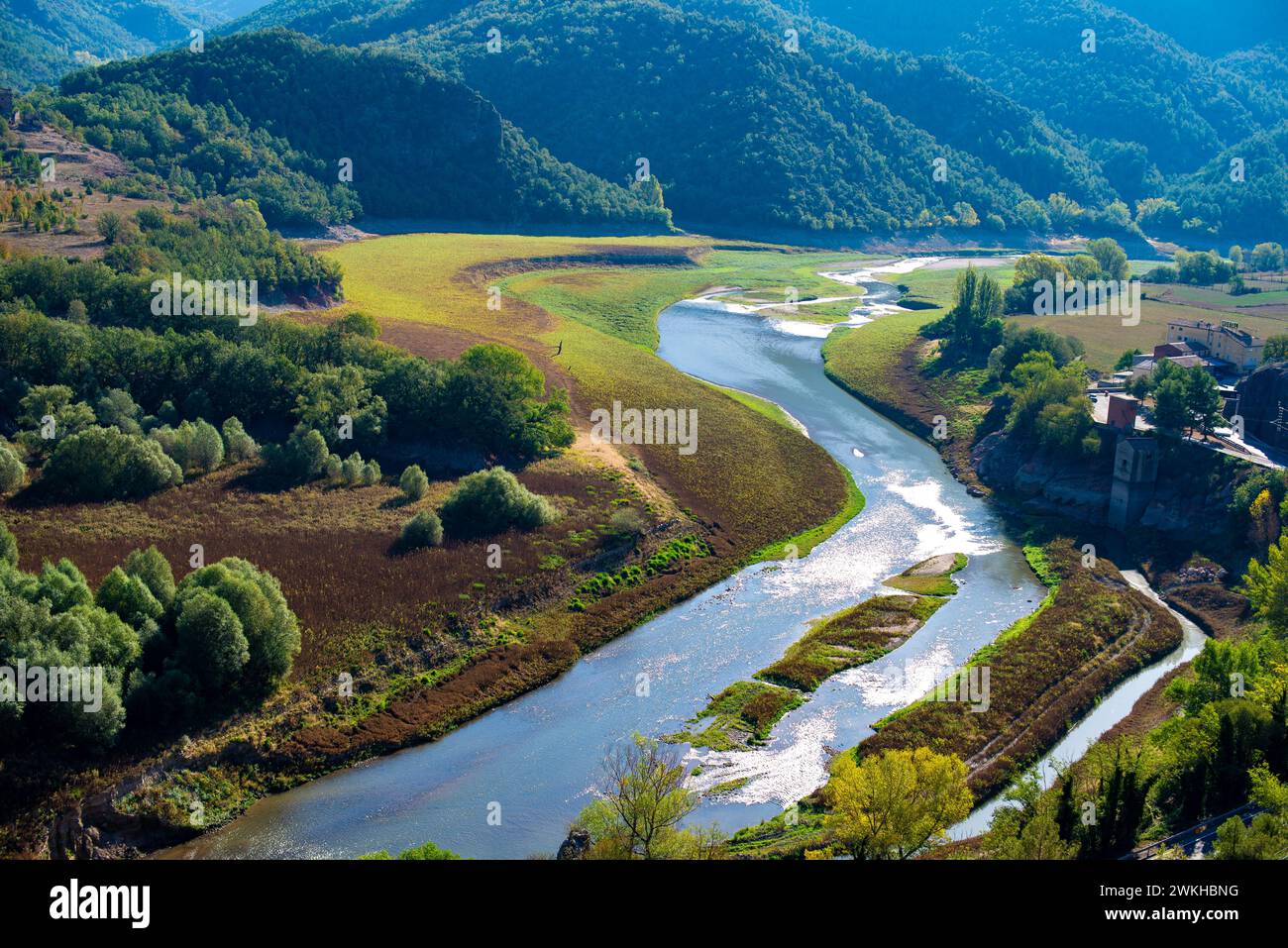 A scenic rural river landscape with hills, grass, and trees Stock Photo ...