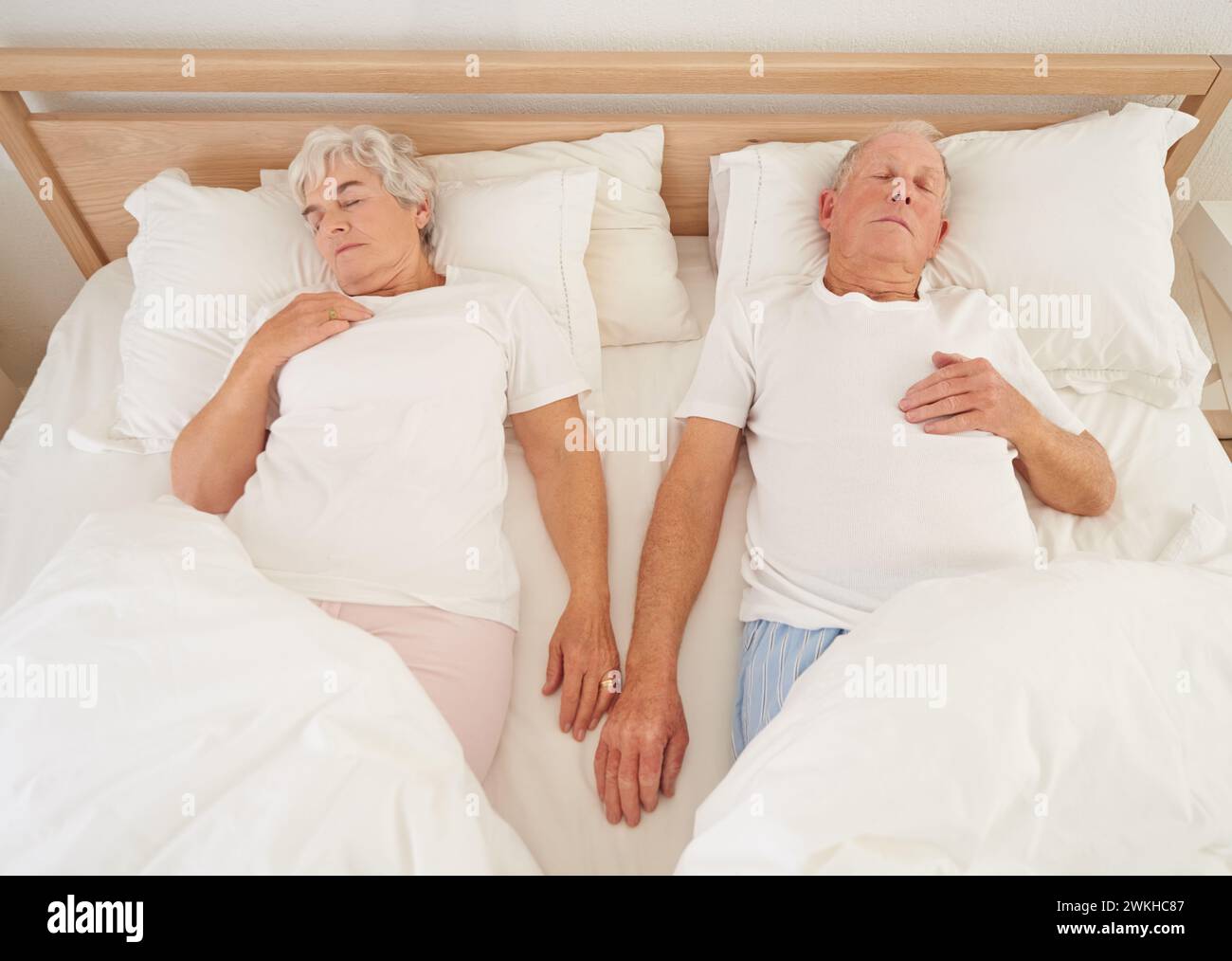 Sleeping, love and senior couple in bed, resting and relaxing together ...