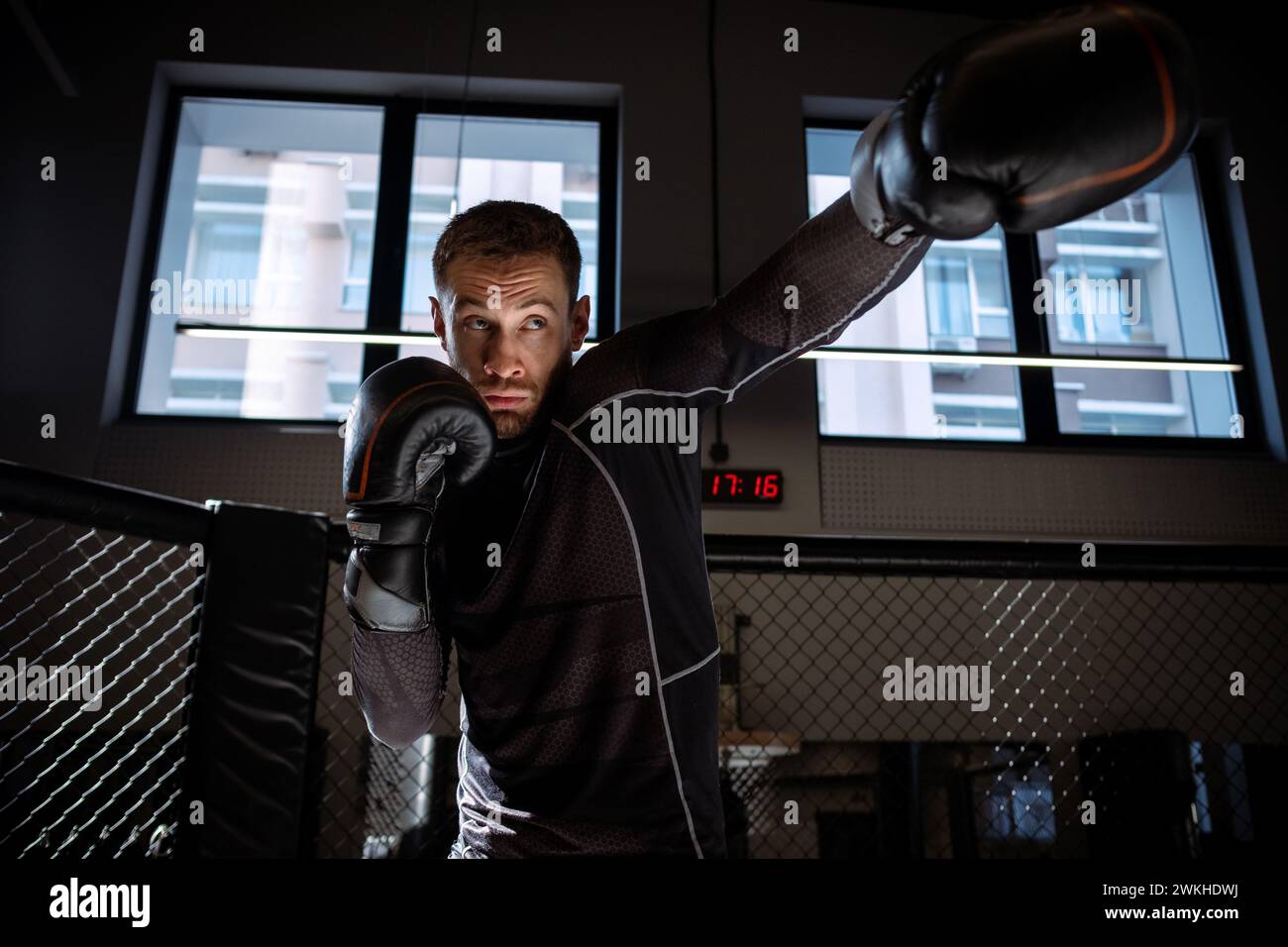 Concentrated boxer honing punching skills while shadowboxing in gym ...