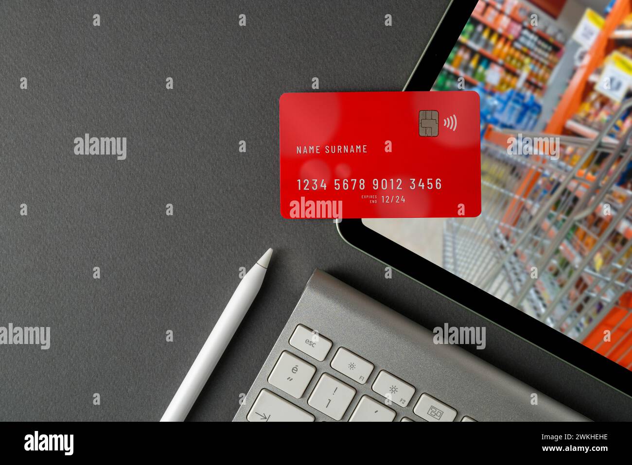 The credit card lies on the tablet and there is a blurry image of the ...