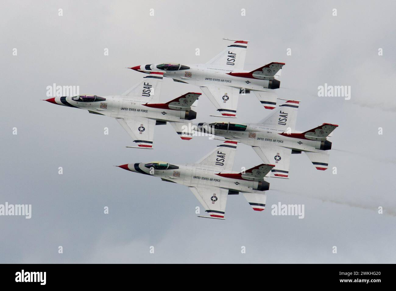 Four fighter jets soaring together in perfect formation through the ...
