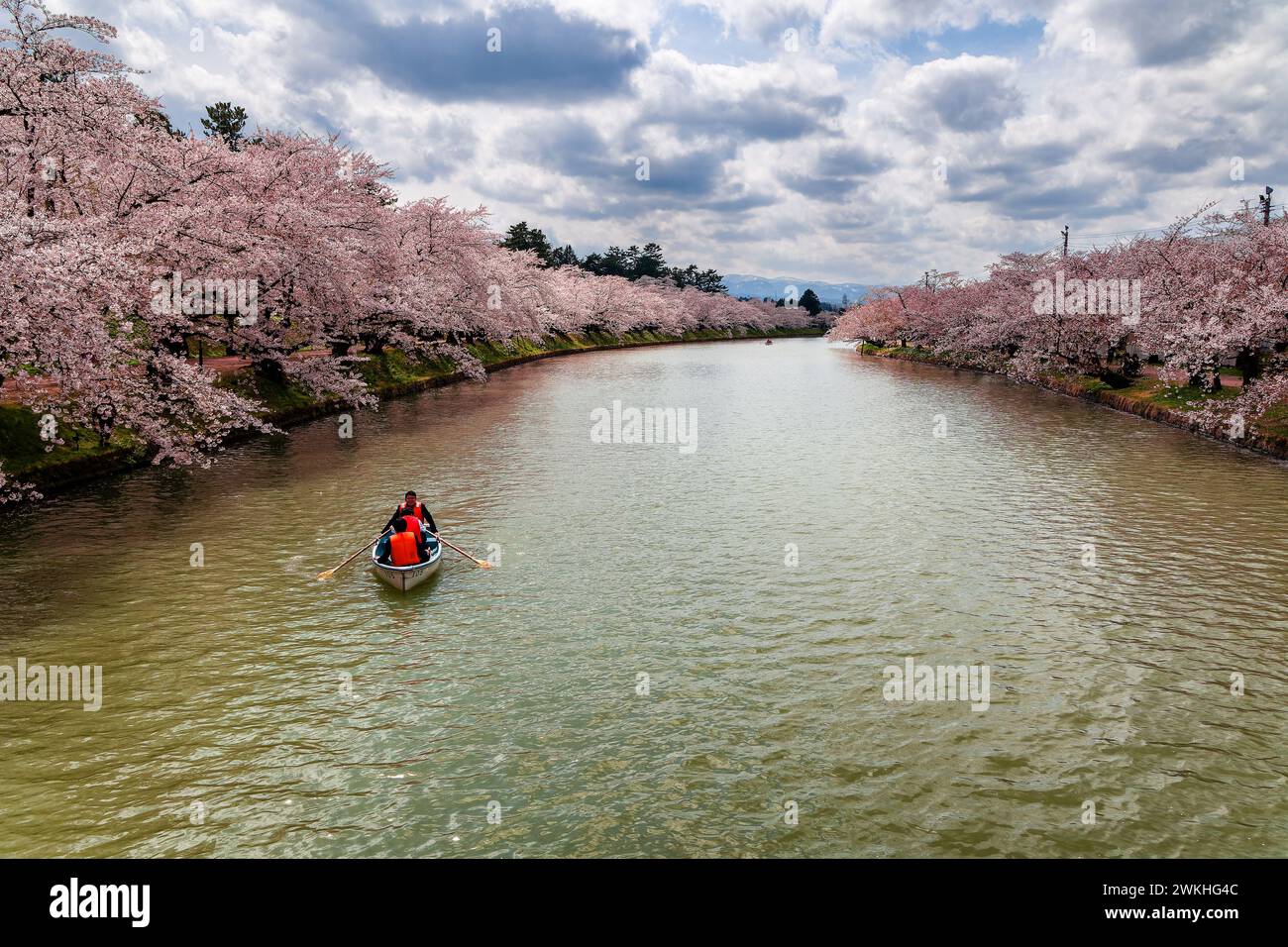 HIROSAKI, JAPAN - APRIL 18 2023: Tourists on wooden boats rowing along ...