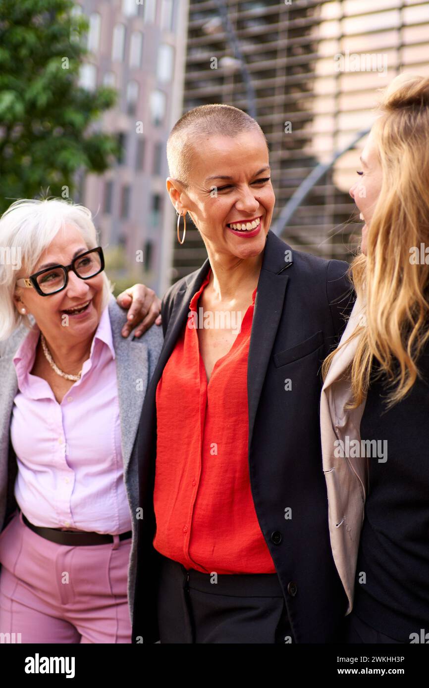 Three diverse business women colleagues enjoying with each other and ...