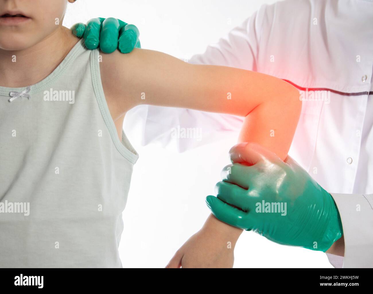 The hands of a traumatologist doctor in green medical gloves examine ...