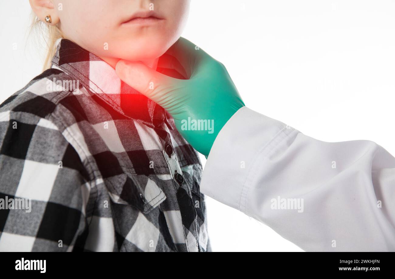 A pediatrician's hand probes the inflamed lymph nodes in a girl's ...