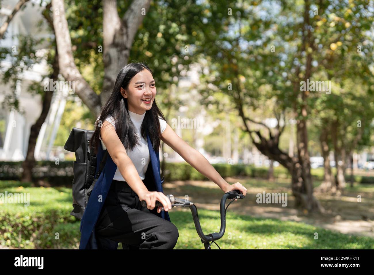 Asian businesswoman in bicycle go to work at office. Bike commuting ...