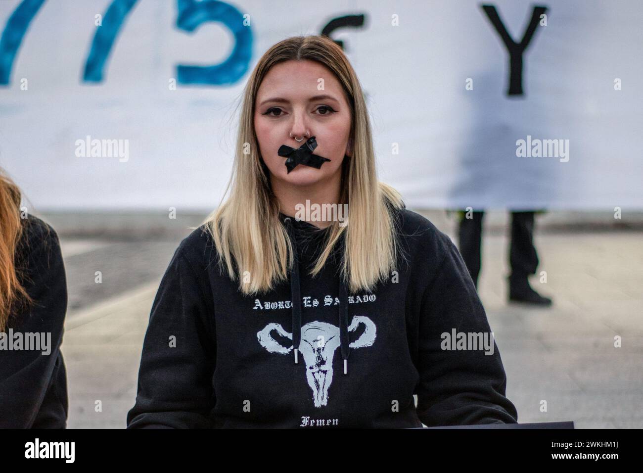 Madrid, Spain. 20th Feb, 2024. An activist with adhesive tape on her ...
