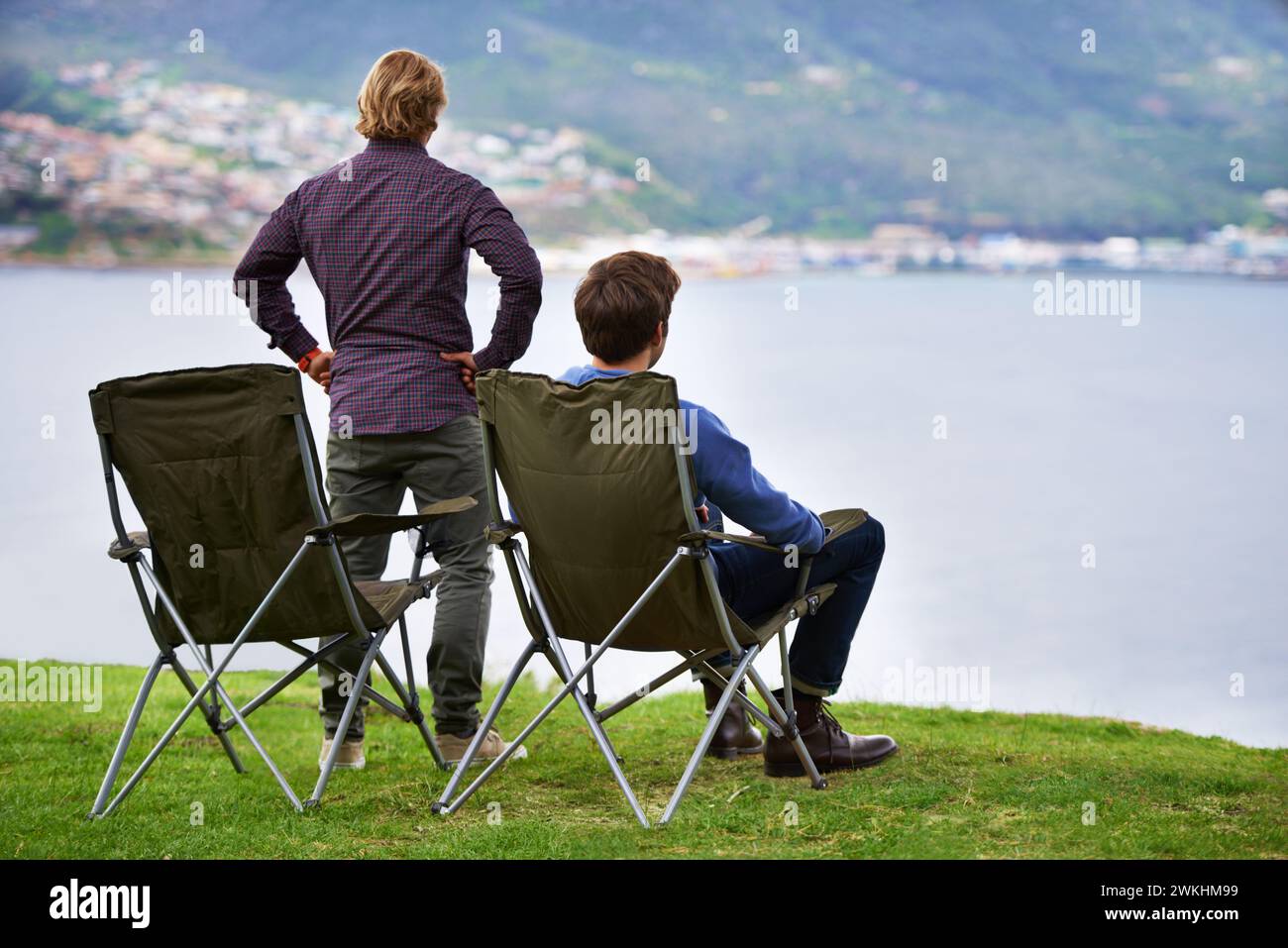 Camping, chair and people relax at lake with landscape in countryside ...